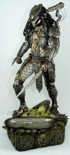 Unpainted predator with gun on shoulder